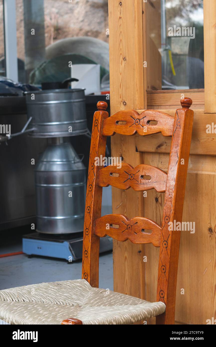 A wooden chair with visible signs of use, such as scratches, dents, and ...