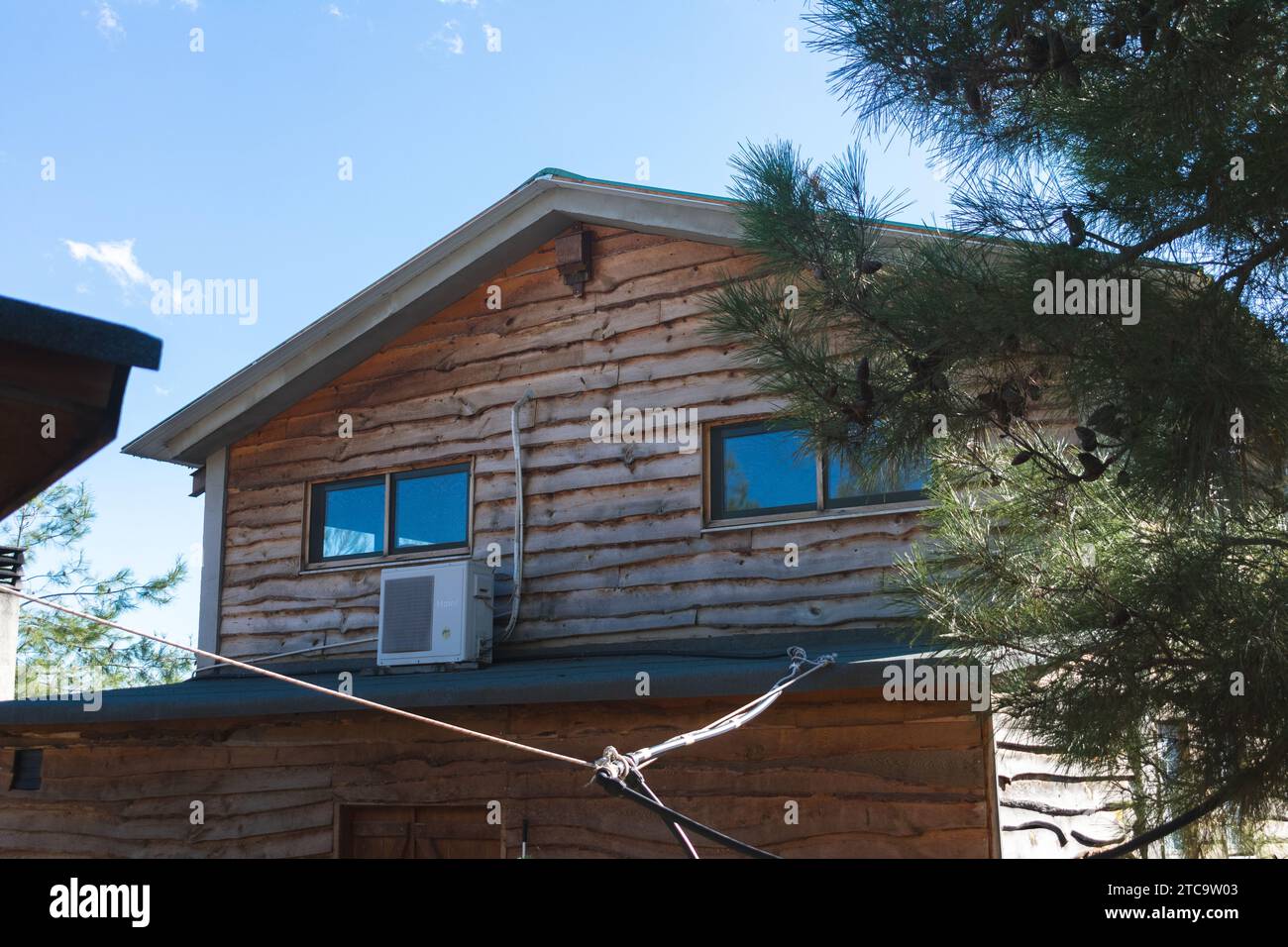 A picturesque wooden cabin in the middle of a field, featuring an ...