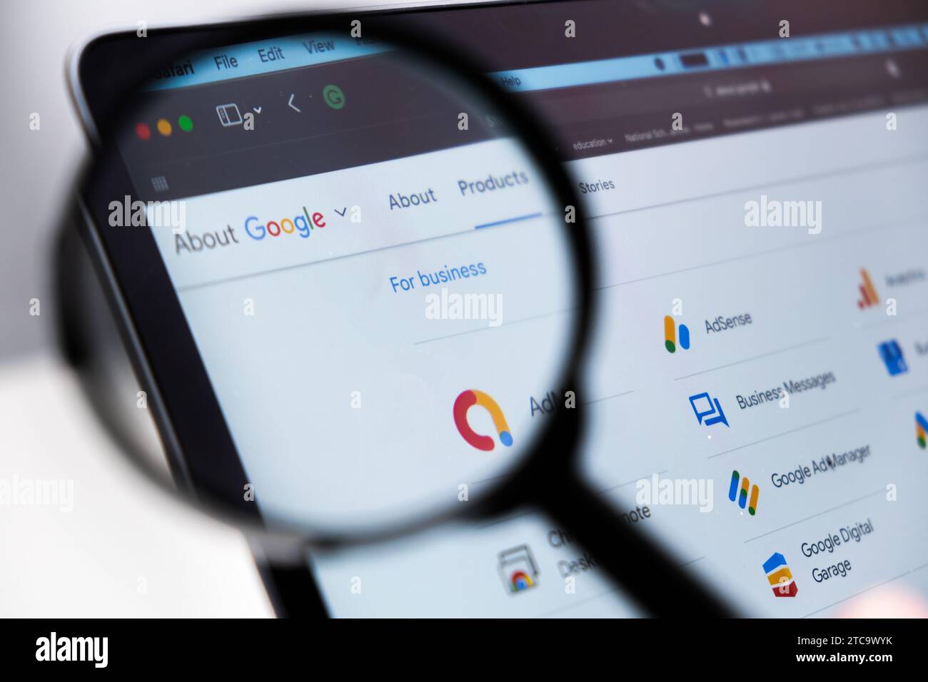 About Google logo on the screen of laptop through magnifying glass ...