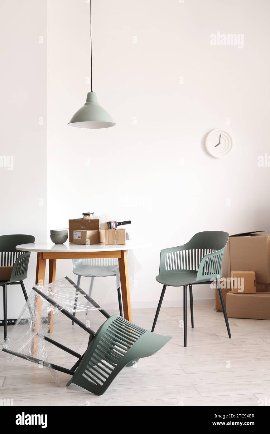 Dining table with cardboard boxes in kitchen on moving day Stock Photo ...