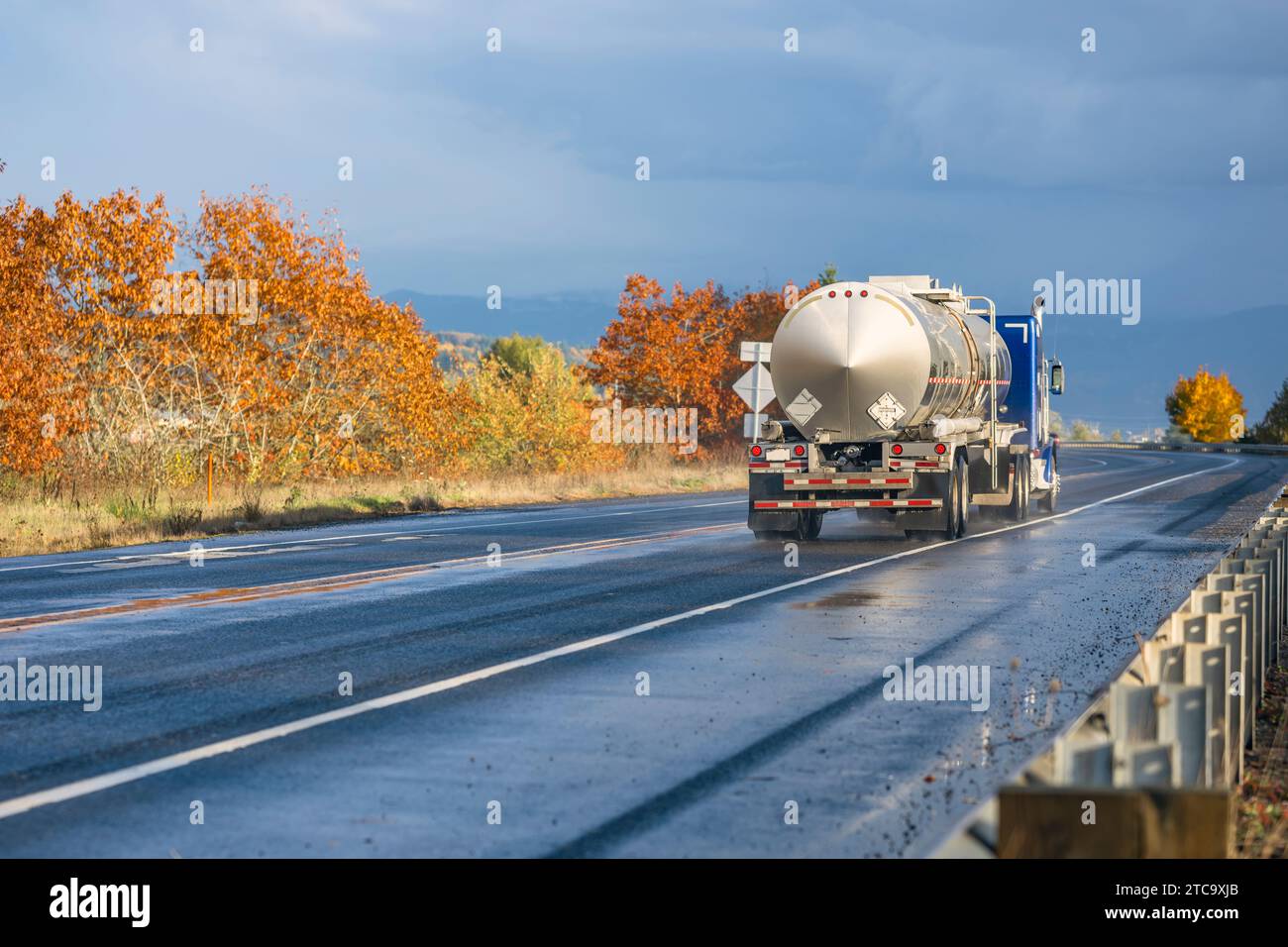 Commercial blue big rig semi truck tractor transporting liquid cargo in ...