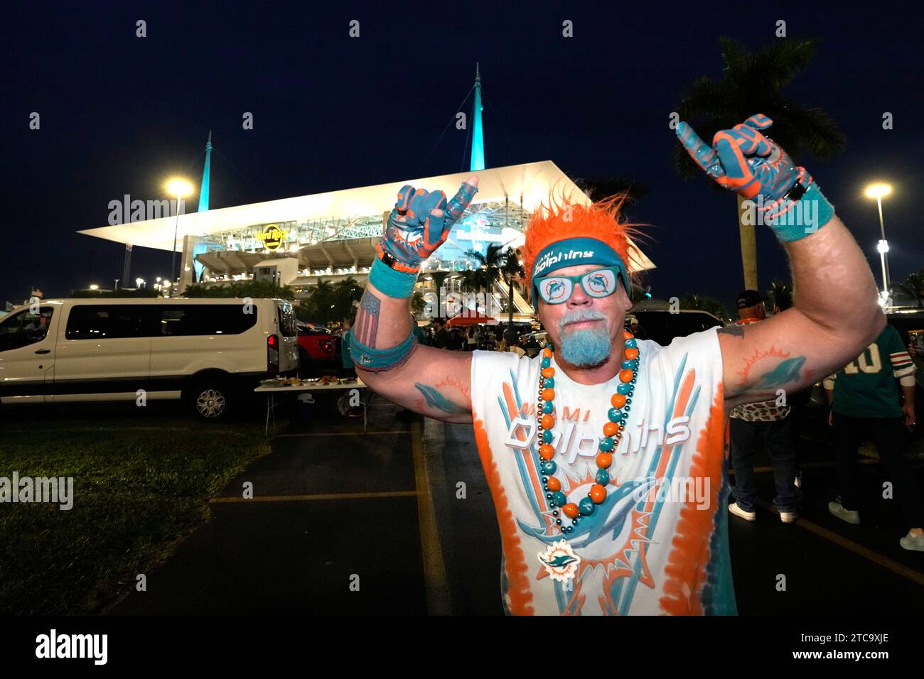 A Dolphins fan tailgates in the parking lot of Hard Rock Stadium before ...