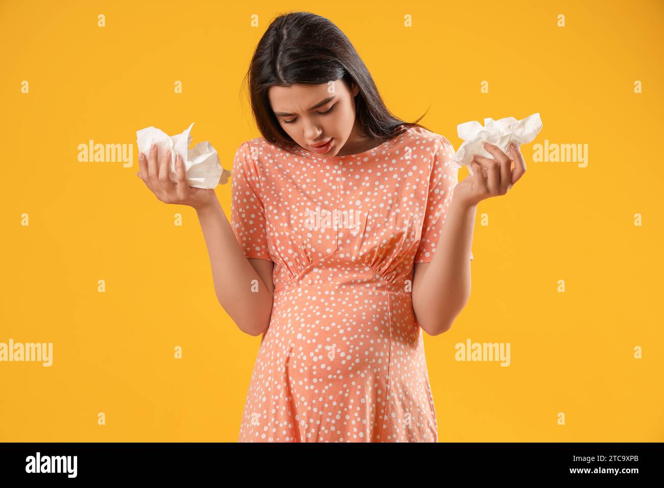 Sick pregnant woman on yellow background Stock Photo - Alamy