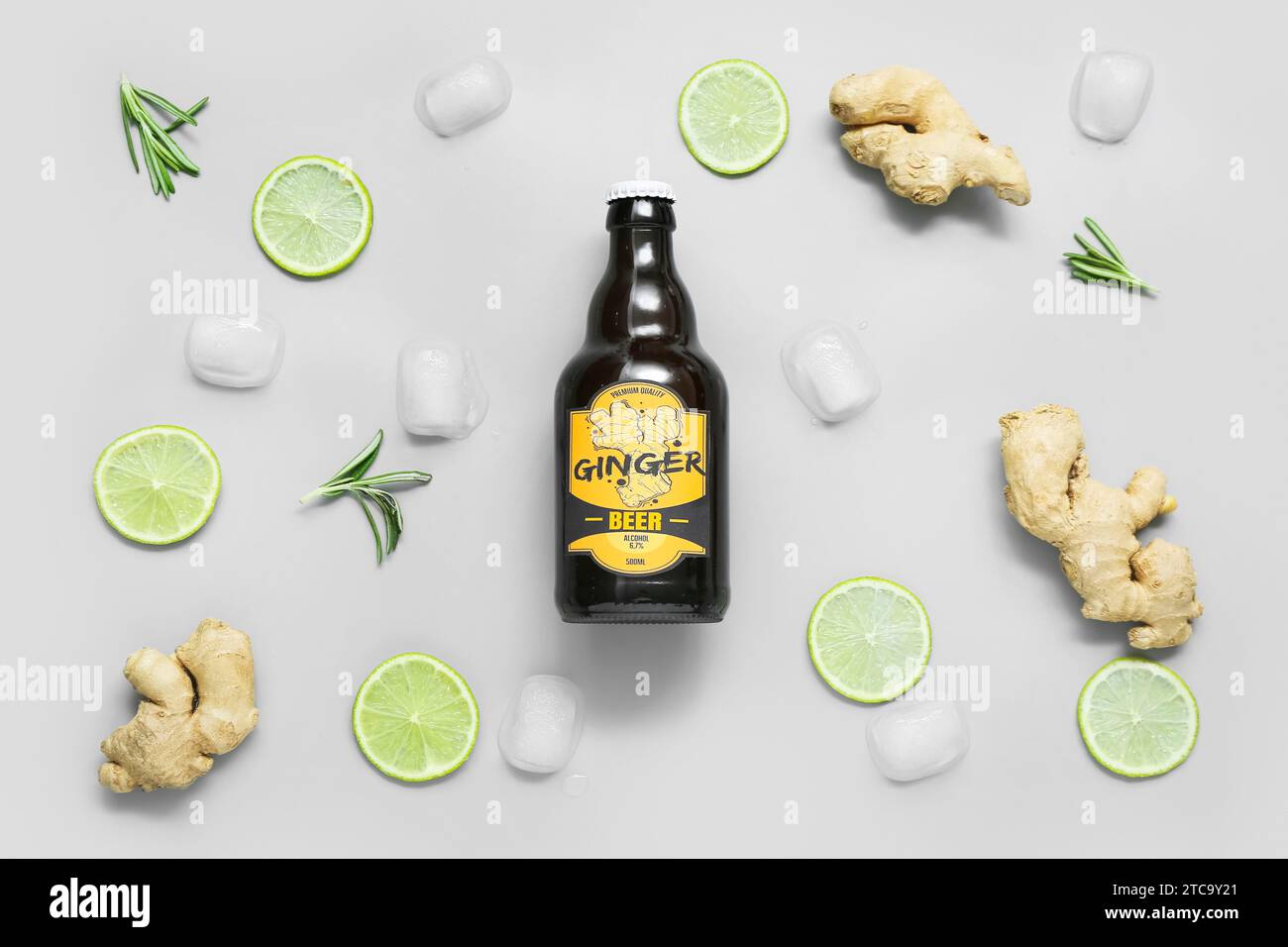 Composition with bottle of fresh ginger beer, lime slices and ice cubes ...
