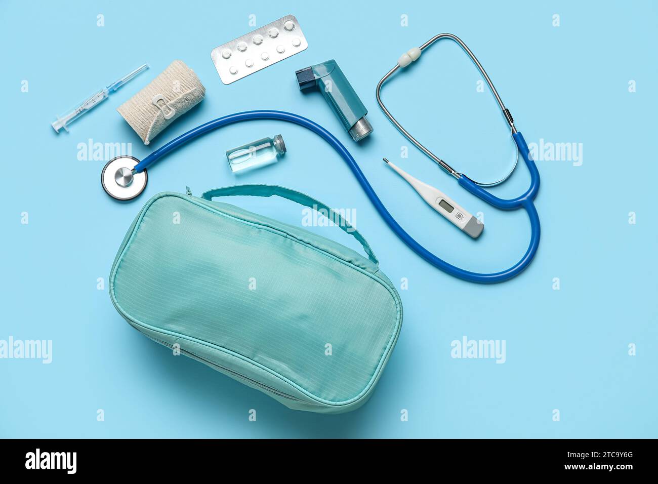First aid kit and pills on blue background Stock Photo - Alamy