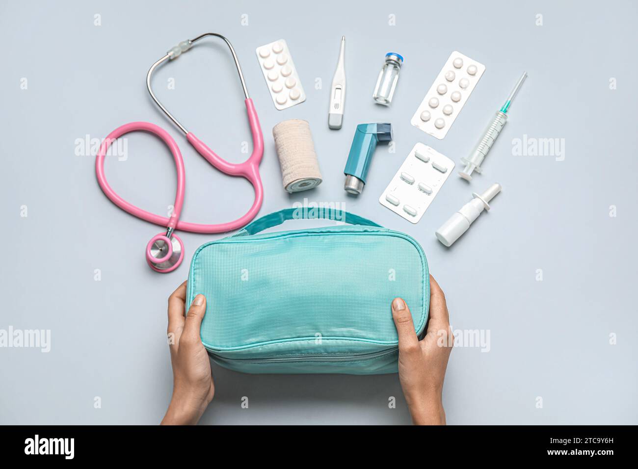 Female hands with first aid kit and pills on grey background Stock ...