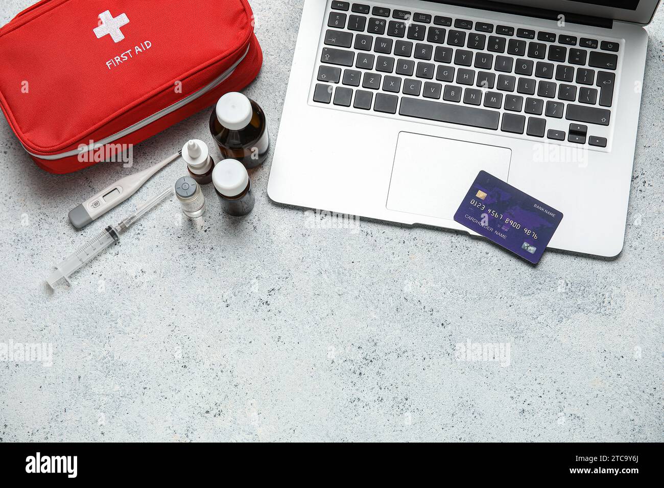 Laptop, credit card and first aid kit on grunge white background Stock ...
