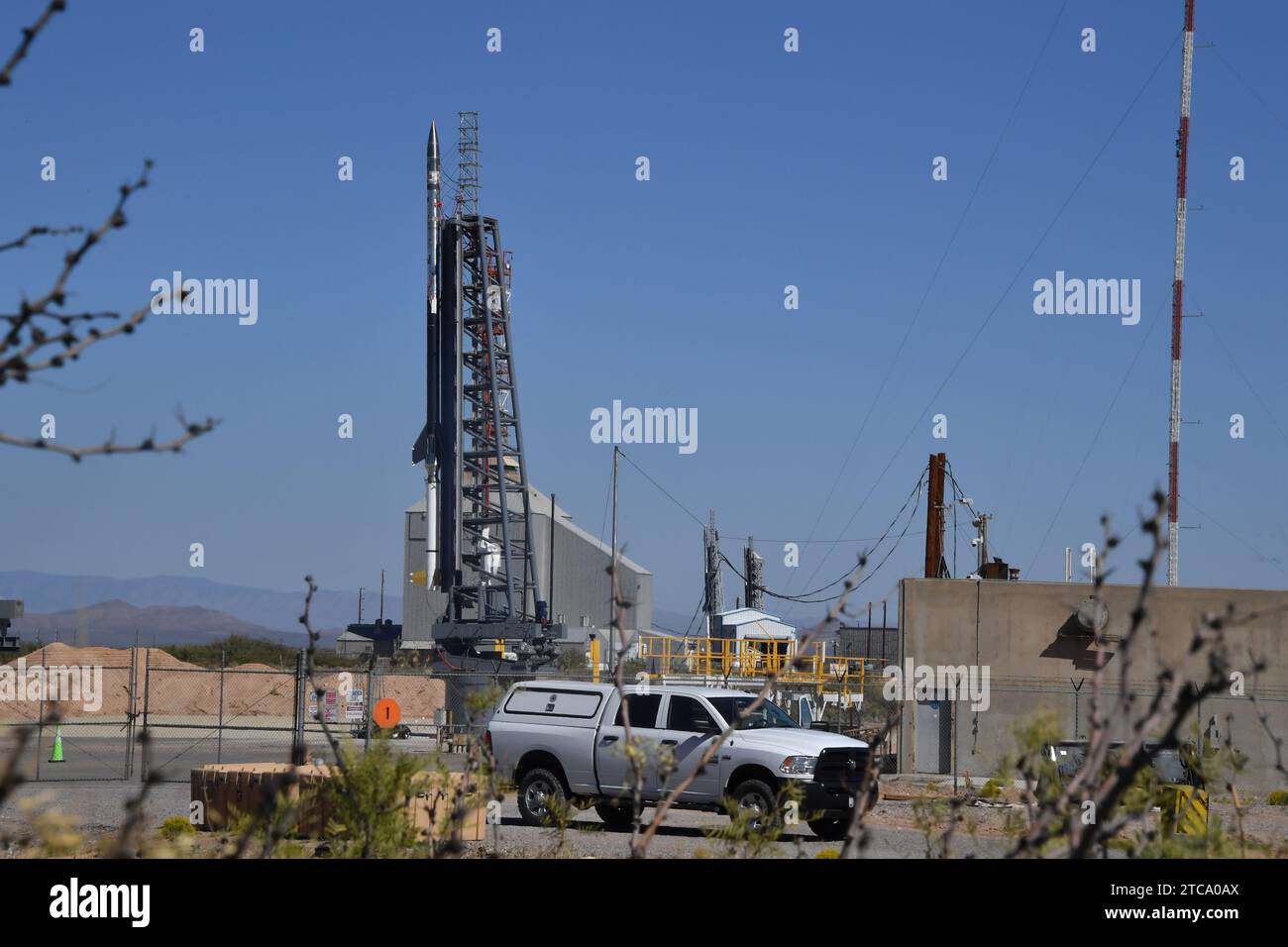 A two-stage sounding rocket stands on a launch rail at Naval Surface ...