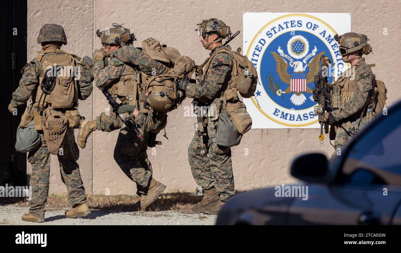 A U.S. Marine with 3rd Battalion, 2d Marine Regiment, 2d Marine Division carries a casualty into ...