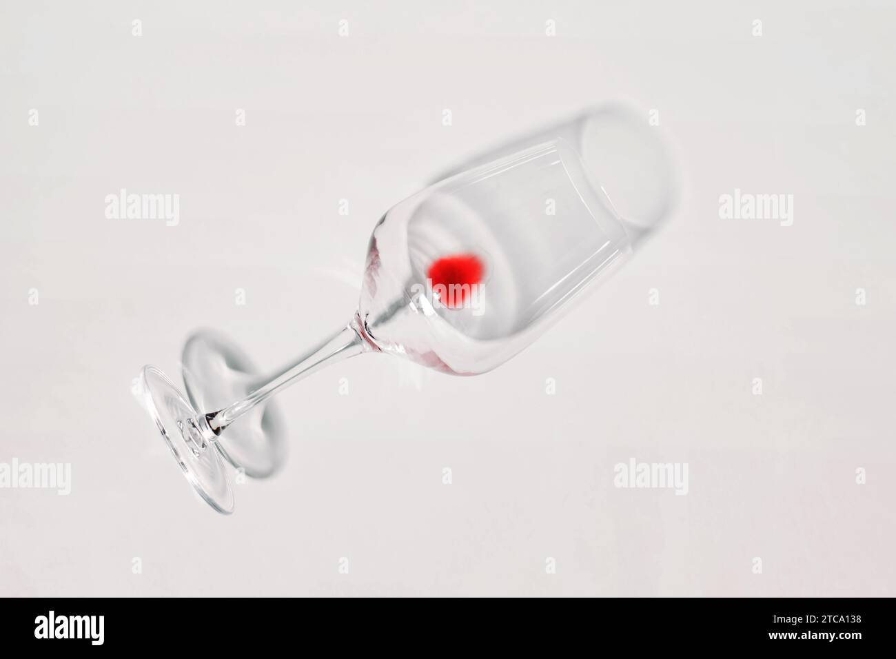 Wine glass with drop of red wine left, isolated on white. Dry january ...