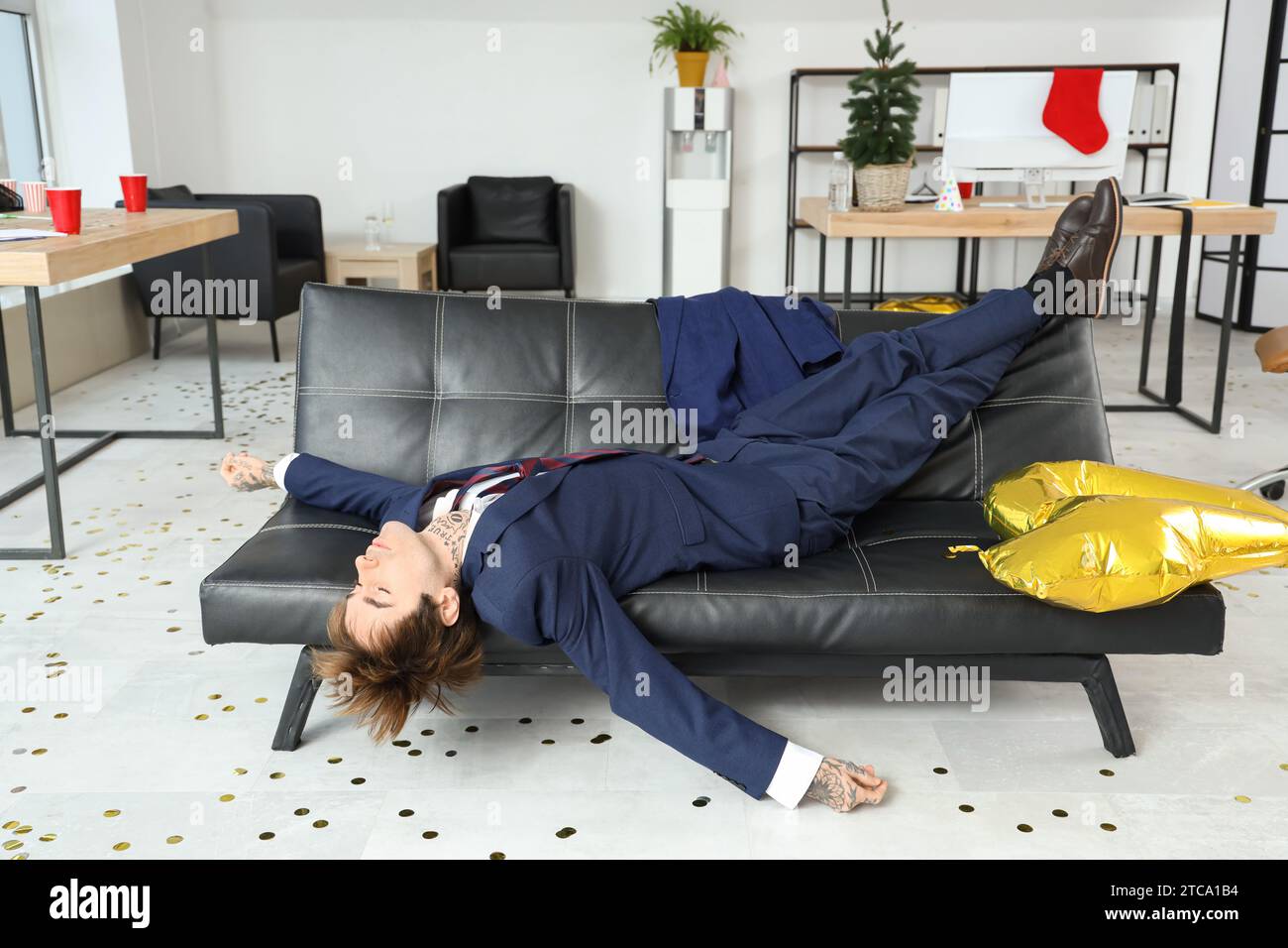 Drunk businessman sleeping on couch after New Year party in office ...