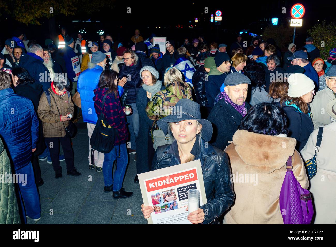 A woman holding a poster with the words kidnapped written on it March ...
