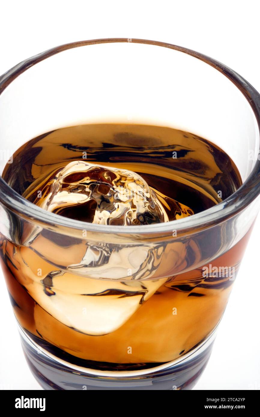 Whiskey on the rocks in an empty old fashioned glass on a white ...