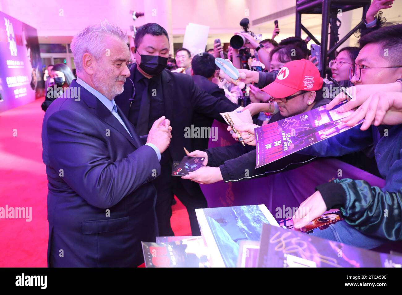 Luc Besson, French director, signs his names for his fans at the ...