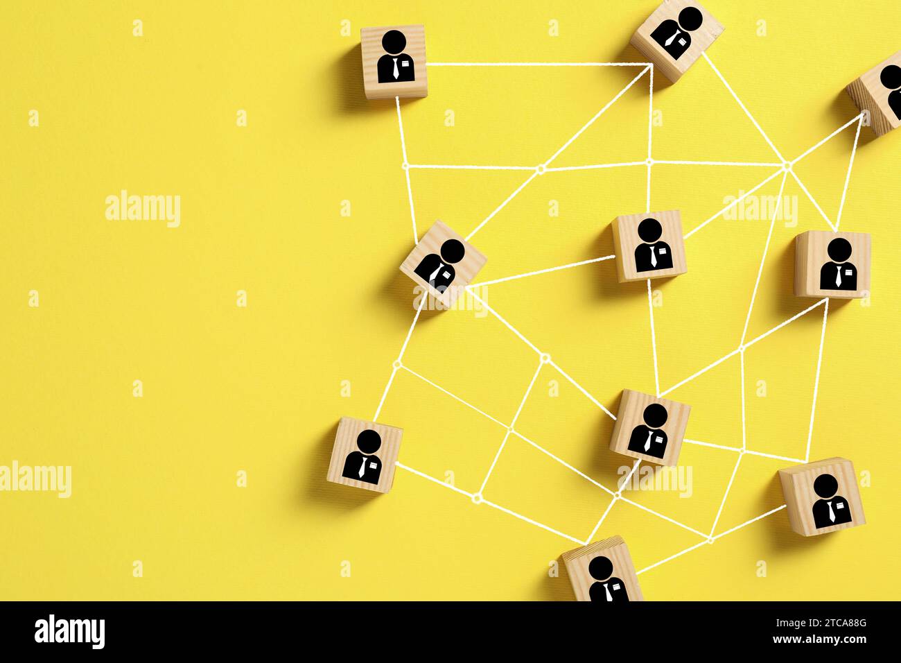 Teamwork. Wooden cubes with human icons linked together symbolizing ...