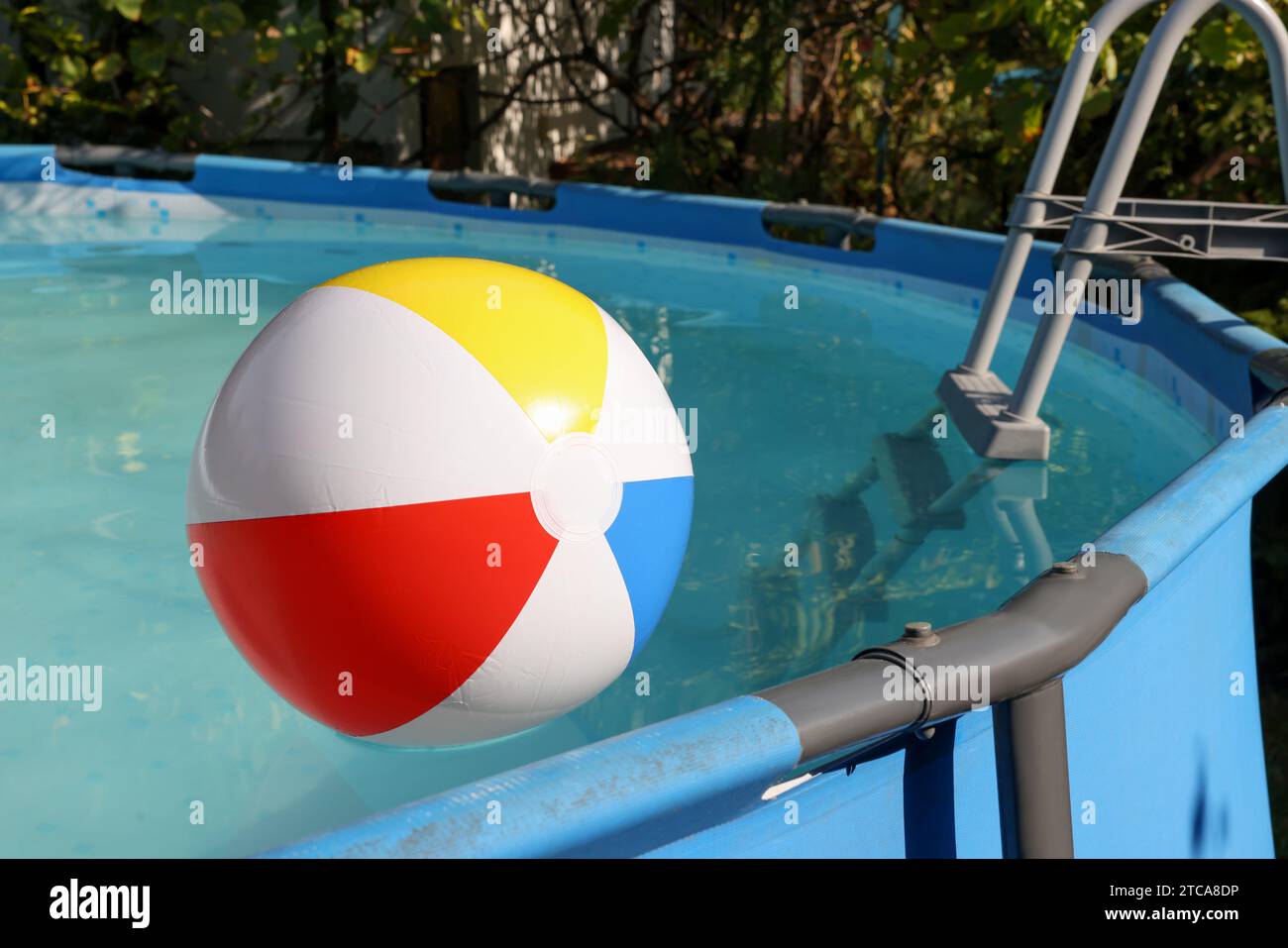 Inflatable ball on water in above ground swimming pool outdoors Stock ...