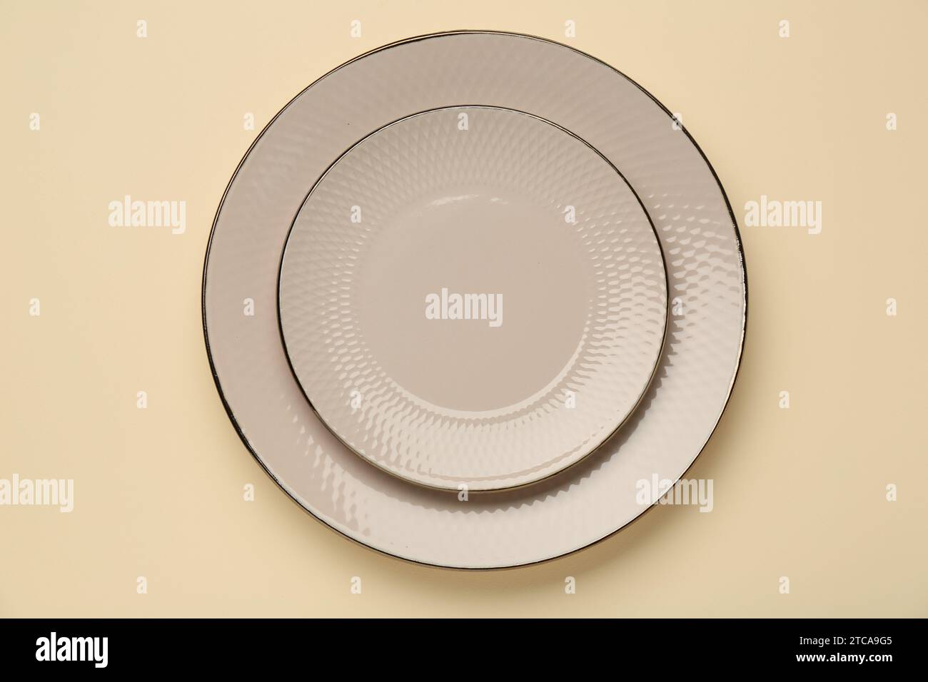 Beautiful ceramic plates on beige background, top view Stock Photo - Alamy