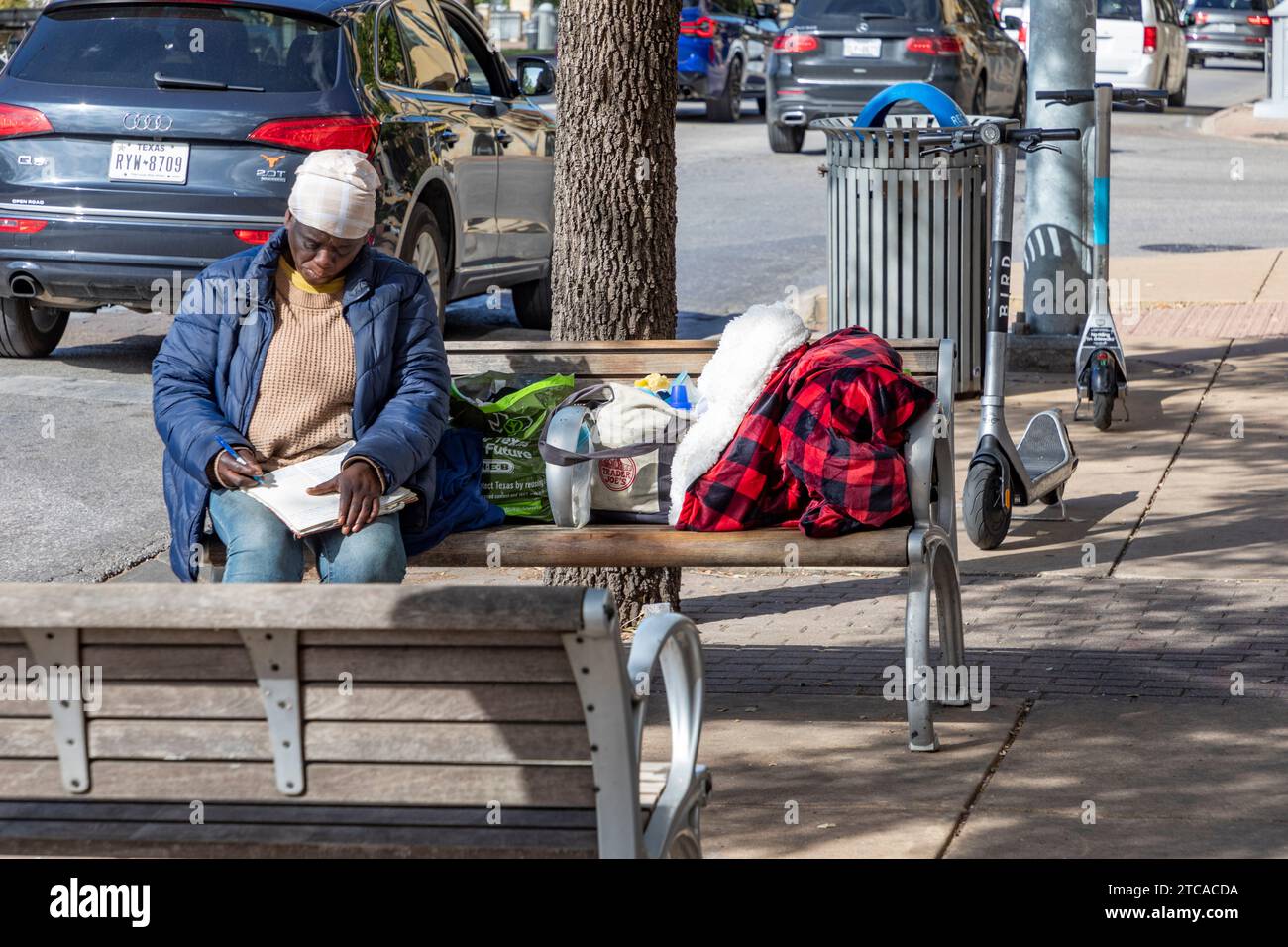 Austin, Texas - November 3, 2023: homeless people sleep at a bench ...