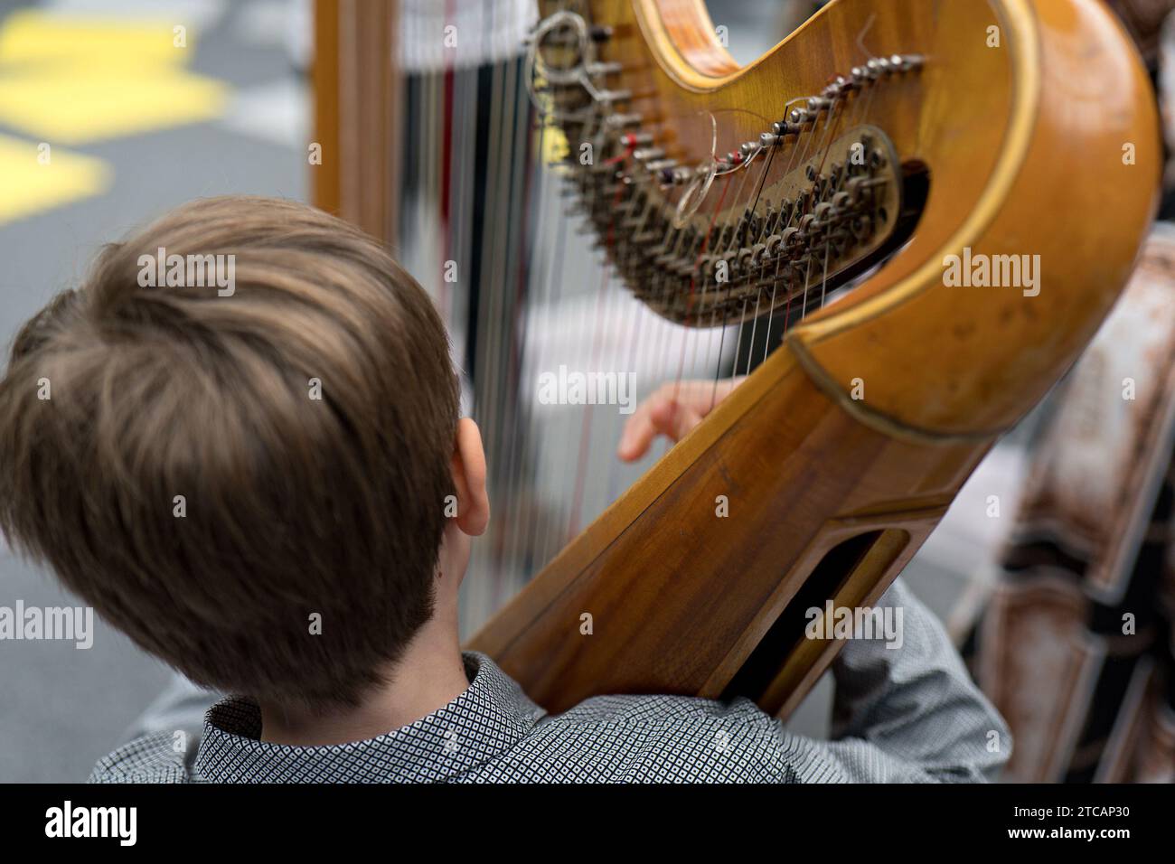 A boy playing the harp Stock Photo - Alamy