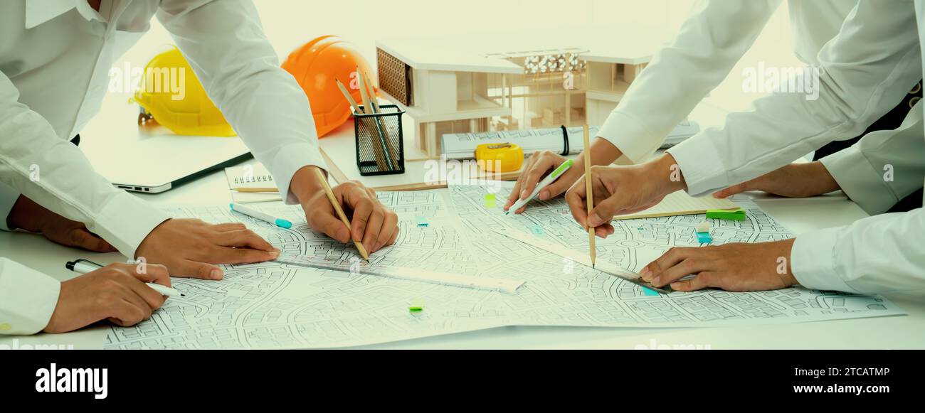Worker, architect and engineer work on real estate construction project ...