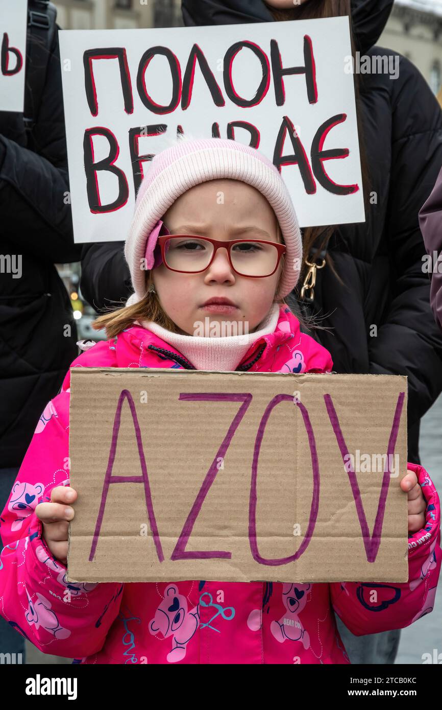 Lviv, Ukraine. 10th Dec, 2023. A little girl holds "Azov" during the ...
