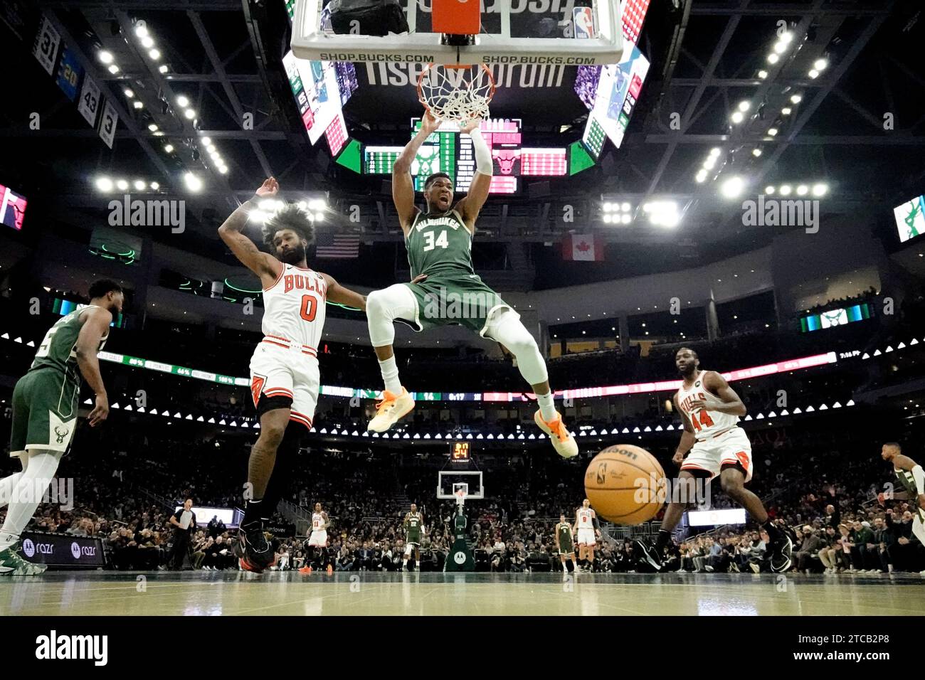Milwaukee Bucks' Giannis Antetokounmpo dunks over Chicago Bulls' Coby White during the first ...