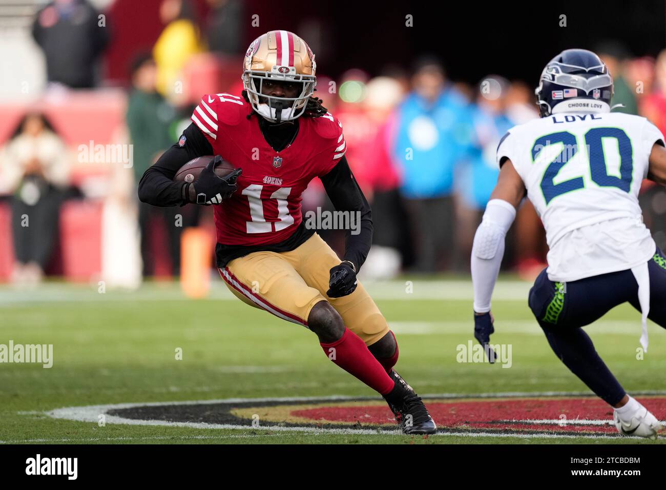 San Francisco 49ers wide receiver Brandon Aiyuk, left, runs with the ...