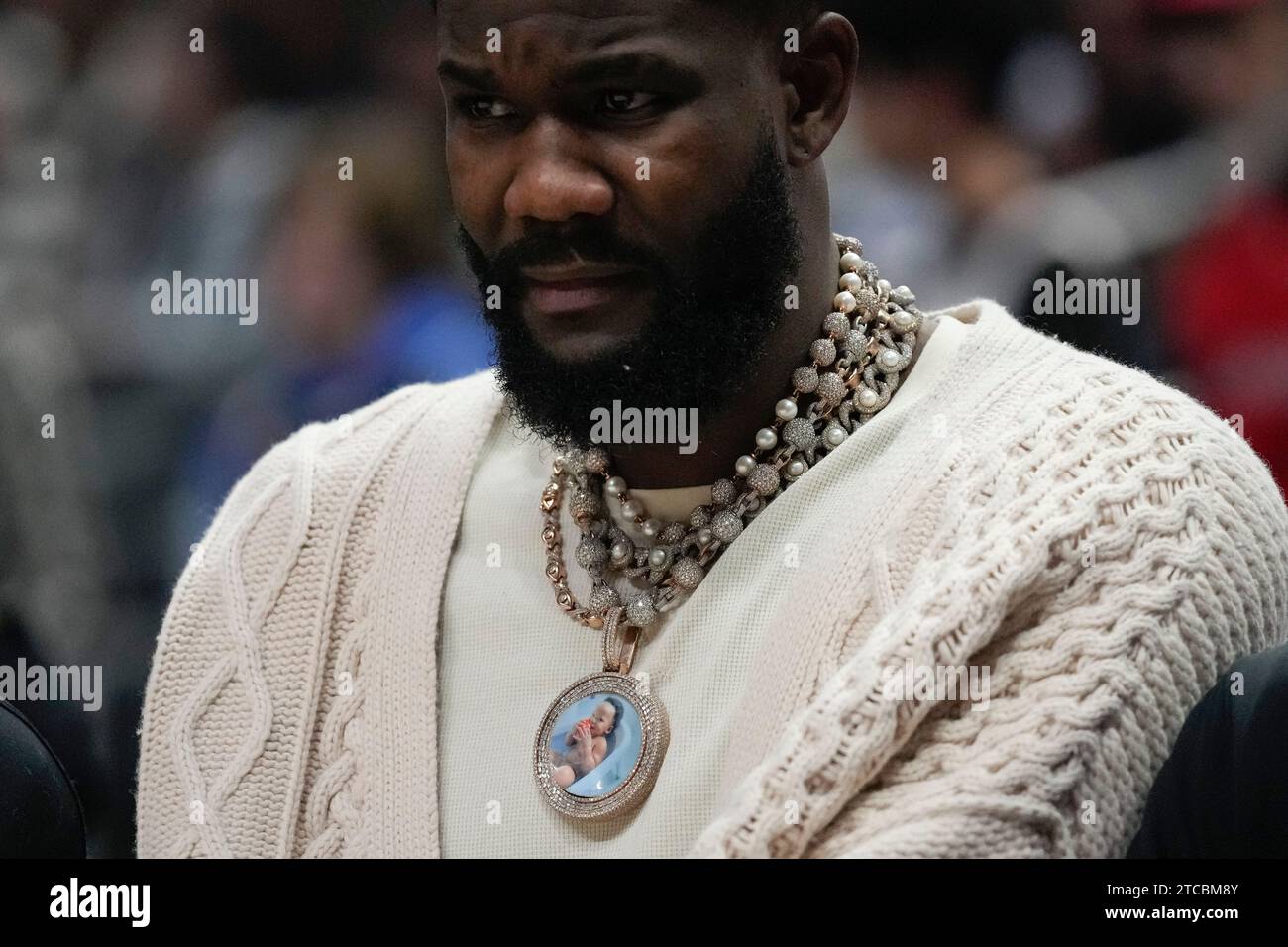 Portland Trail Blazers' Deandre Ayton wears a pendant while sitting on ...