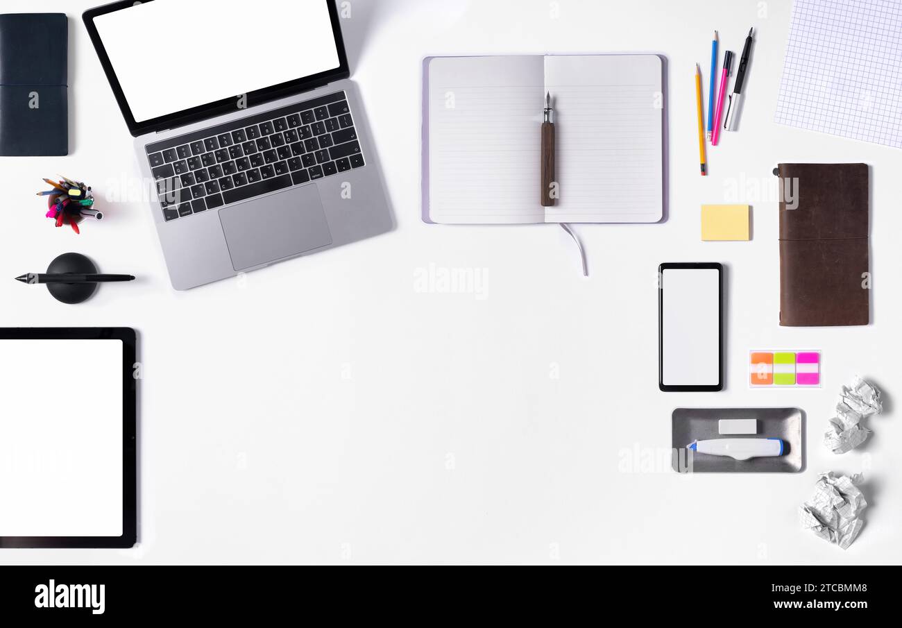 Laptops and stationery for work on the desk are arranged (blank screen ...