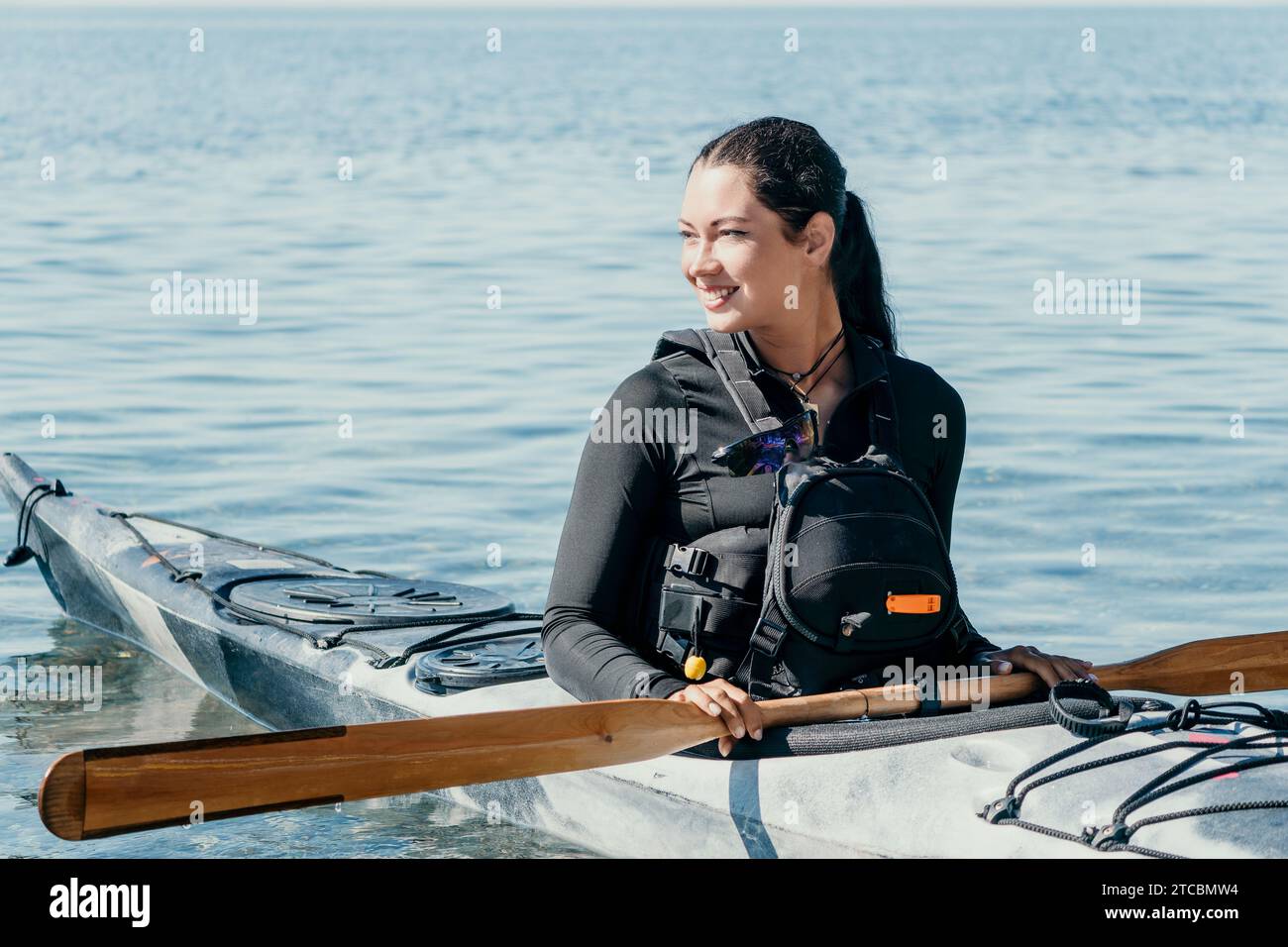 Woman sea kayak. Happy smiling woman in kayak on ocean, paddling with ...
