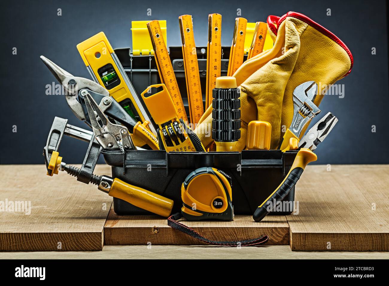 Toolbox with many building tools on wooden boards Stock Photo - Alamy