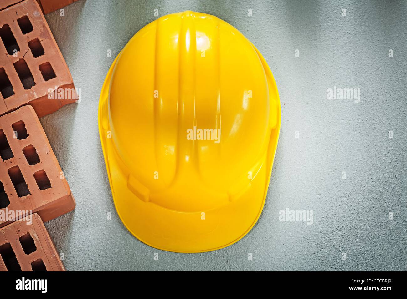 Composition of building blocks Safety helmet on concrete Background ...