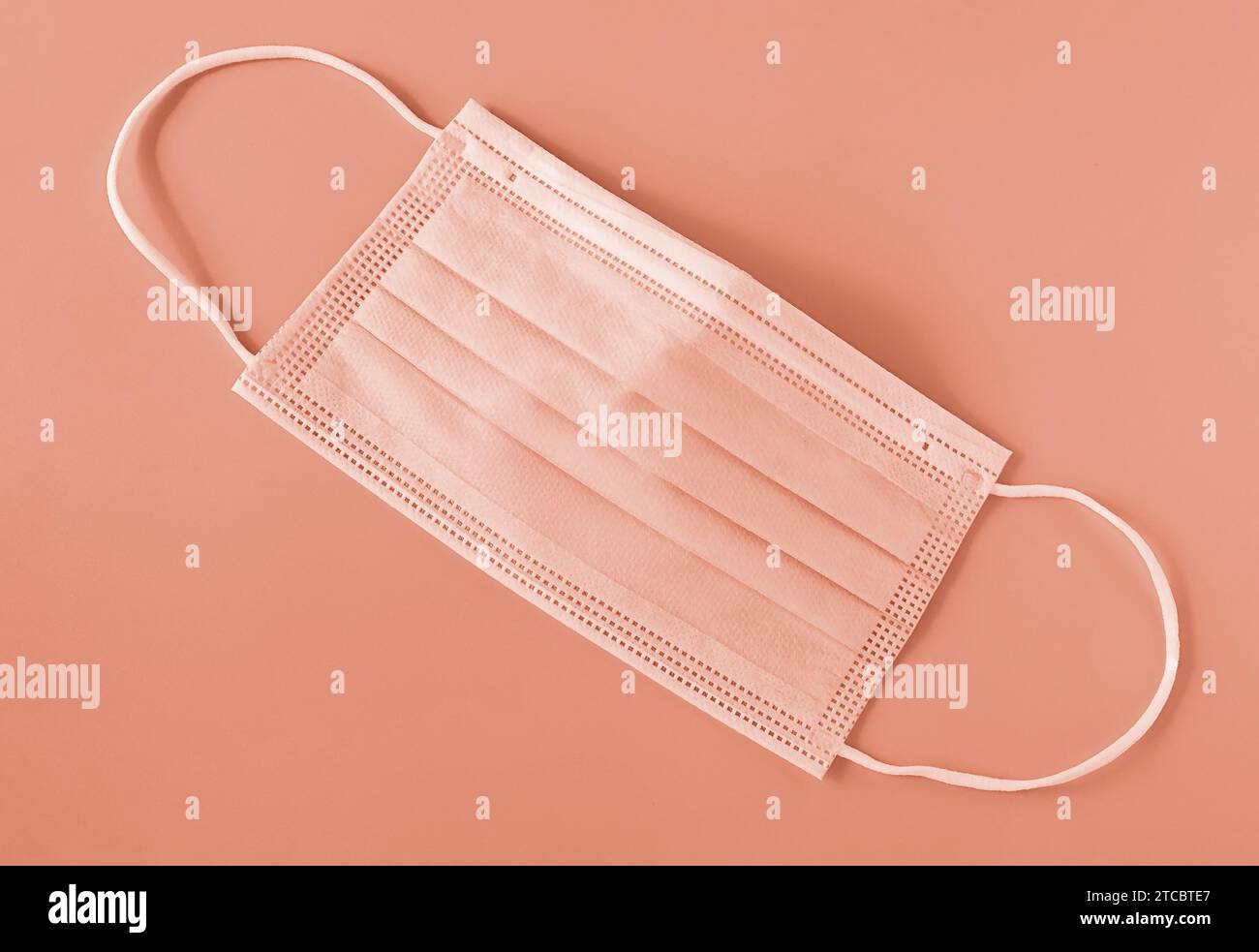 Medical mask, color of year 2024 peach fuzz Stock Photo - Alamy