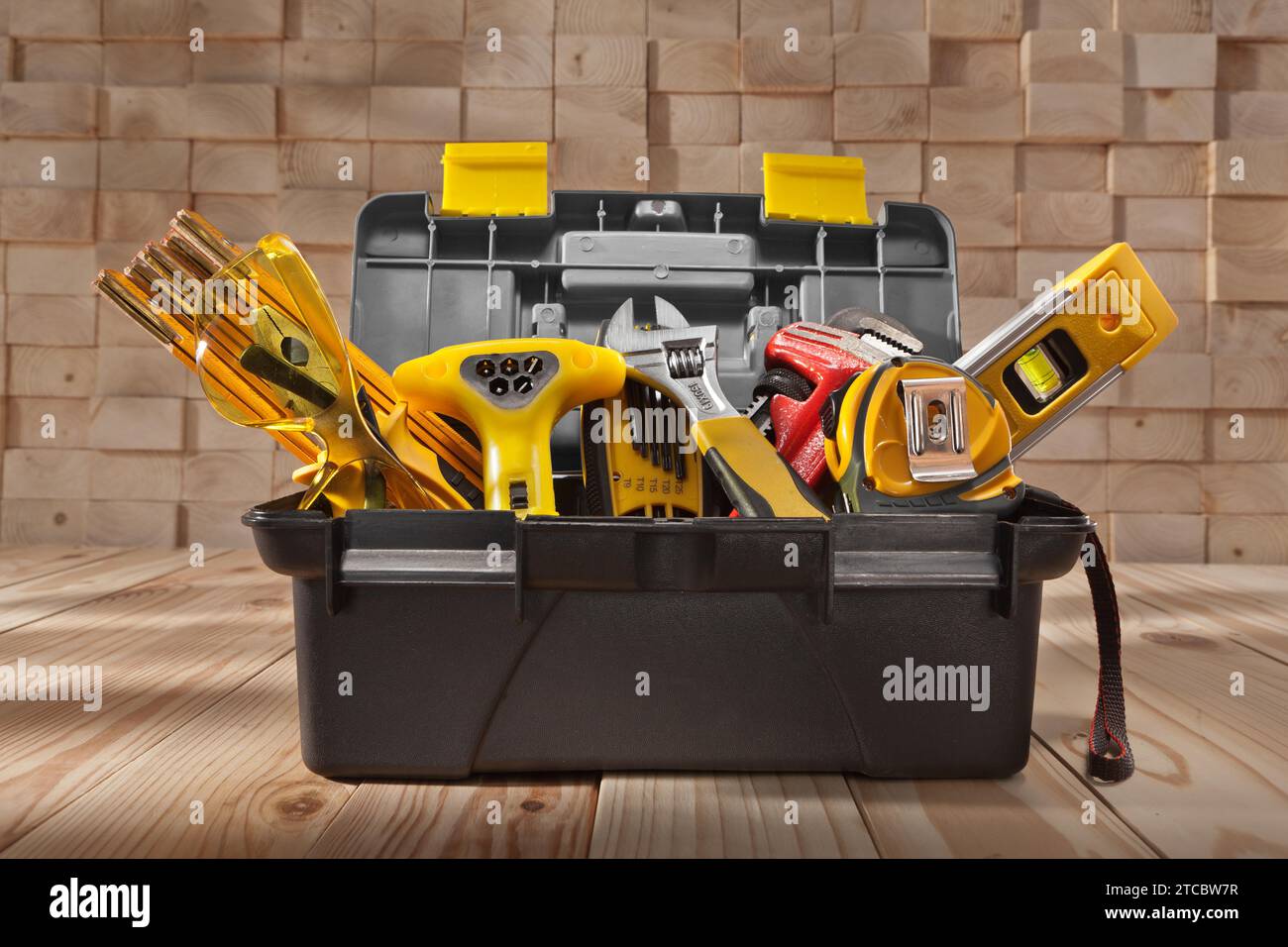 Various work tools in a small black toolbox. On the background of ...