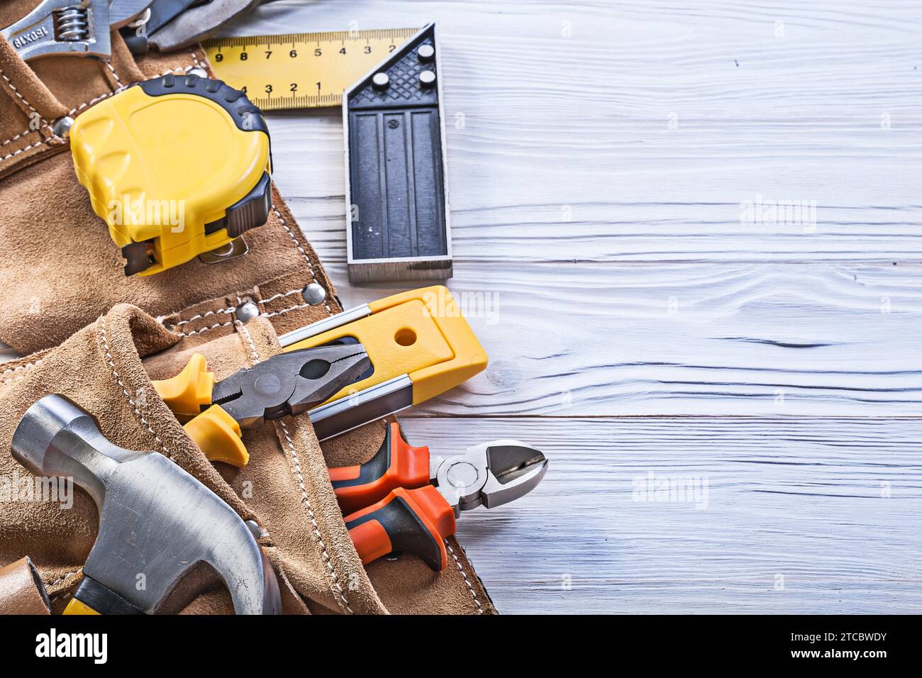 Construction tools in leather Building belt on wooden board Maintenance ...