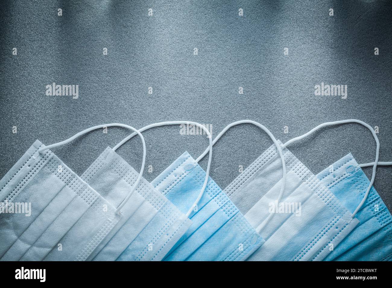 Disposable medical masks on a grey background Stock Photo - Alamy