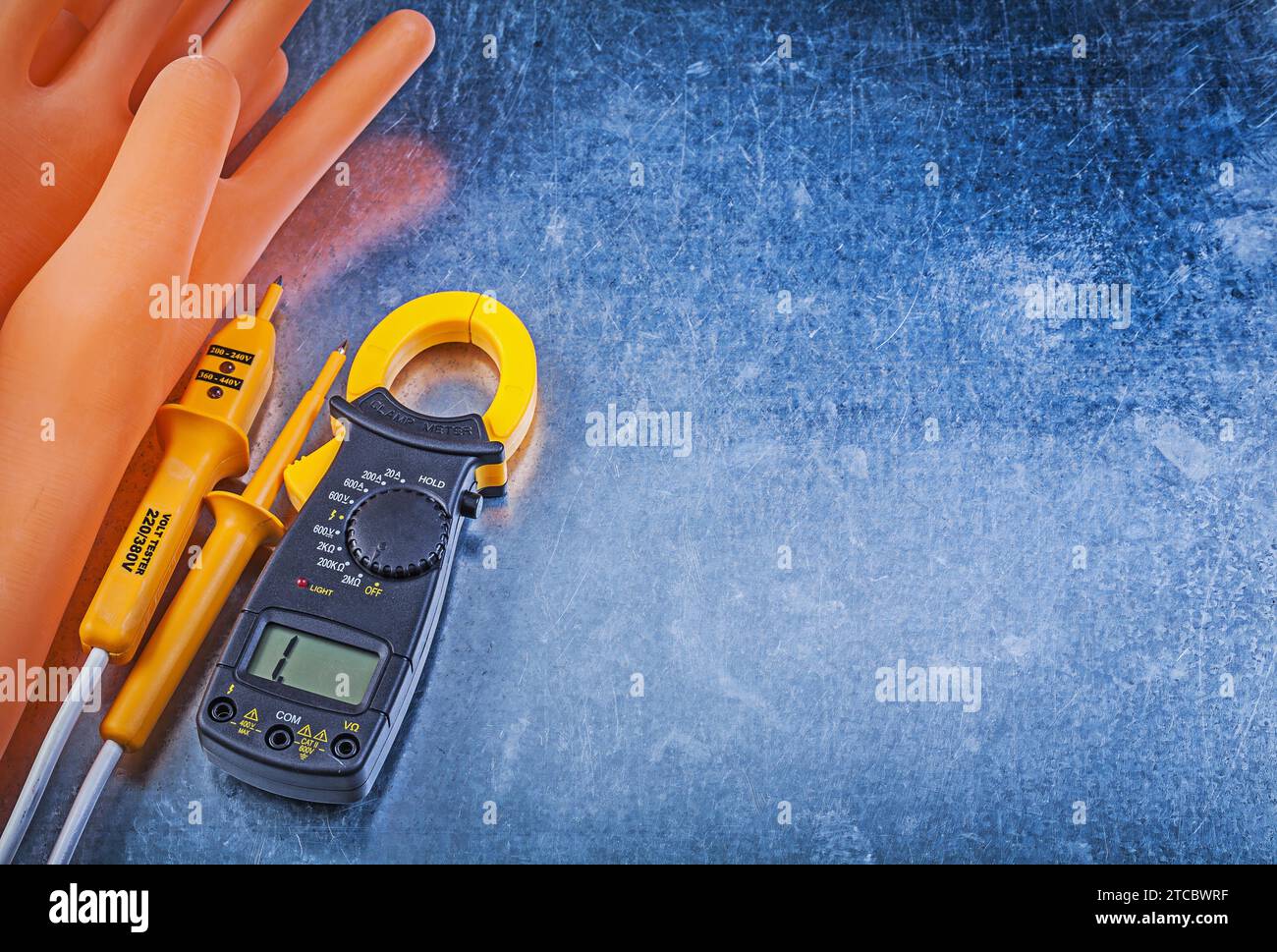 Digital clamp meter Electrical tester Electrician Rubber gloves on ...