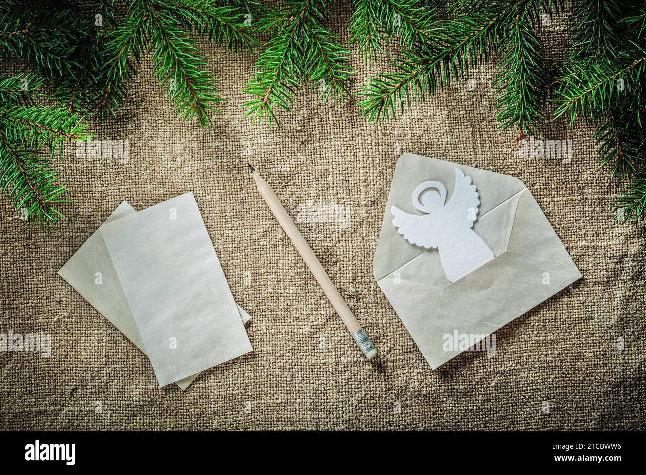 Fir branch envelope paper angel pencil on bagging surface Stock Photo ...