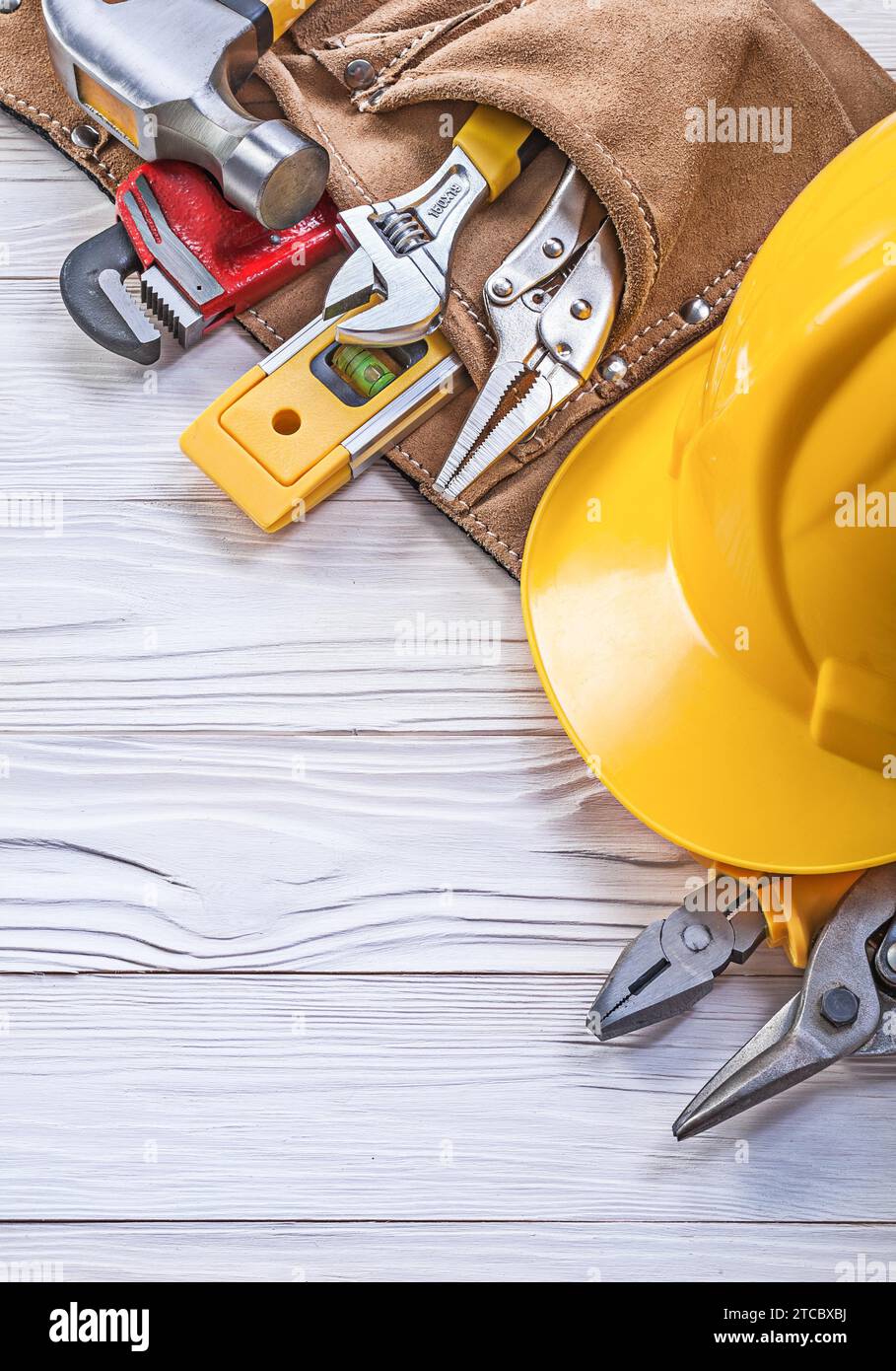 Leather construction belt hard hat on wooden board maintenance concept ...