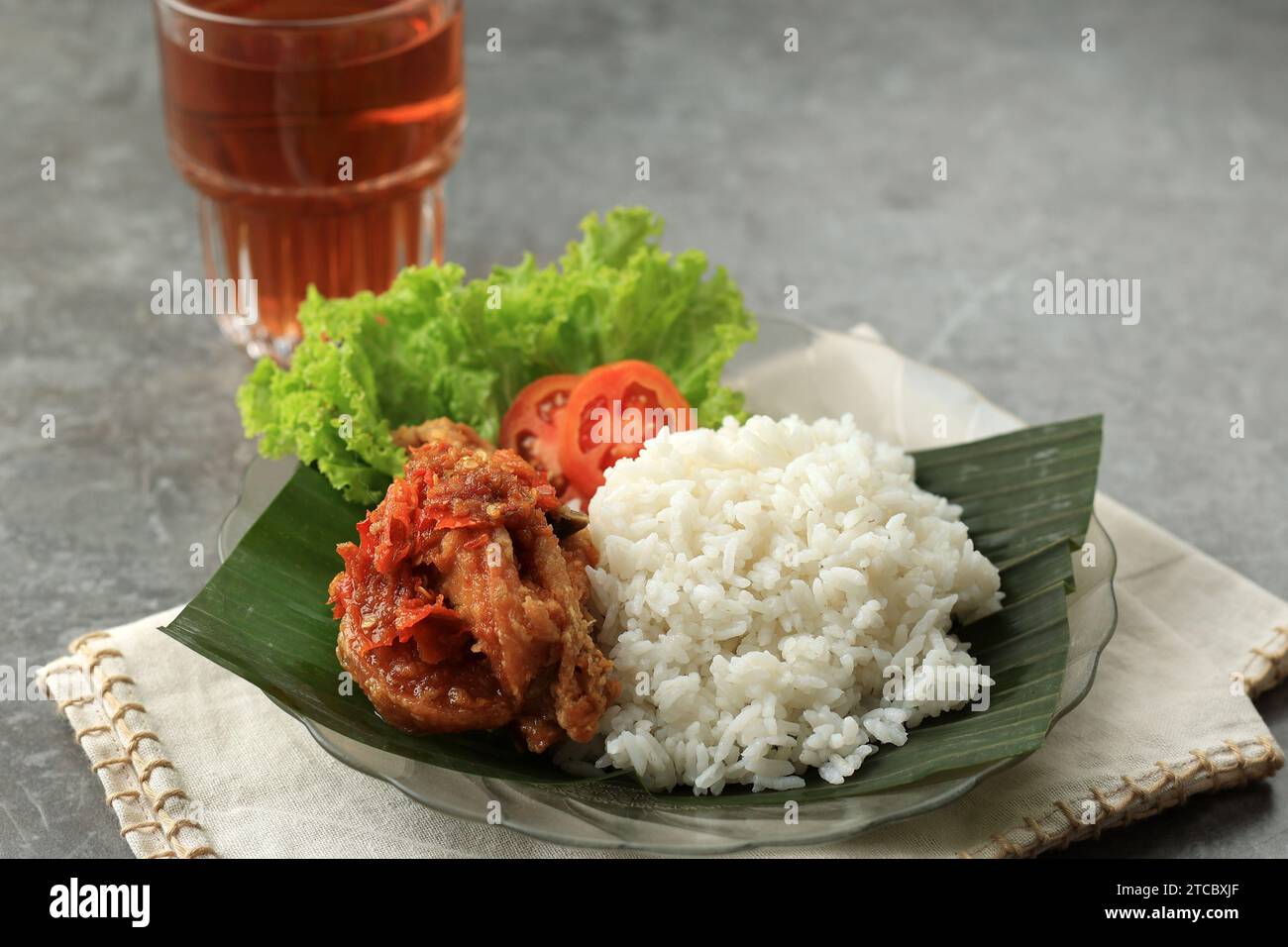 Nasi Ayam Penyet, Indonesian Spicy Chicken with Various Fresh Vegetable ...