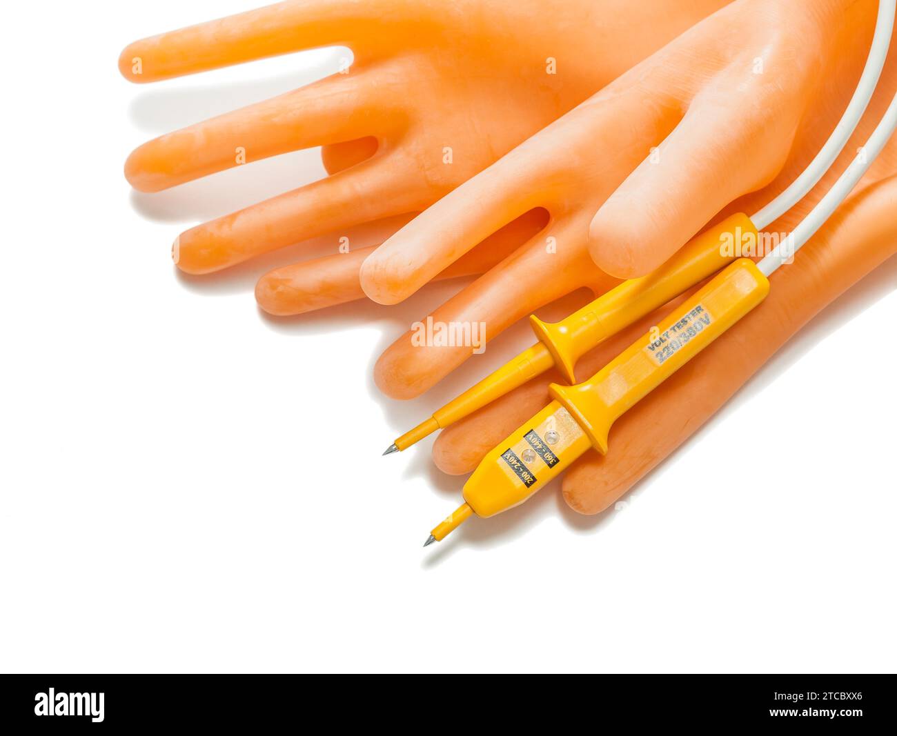 Electrical tools dielectric gloves and testers against a white ...