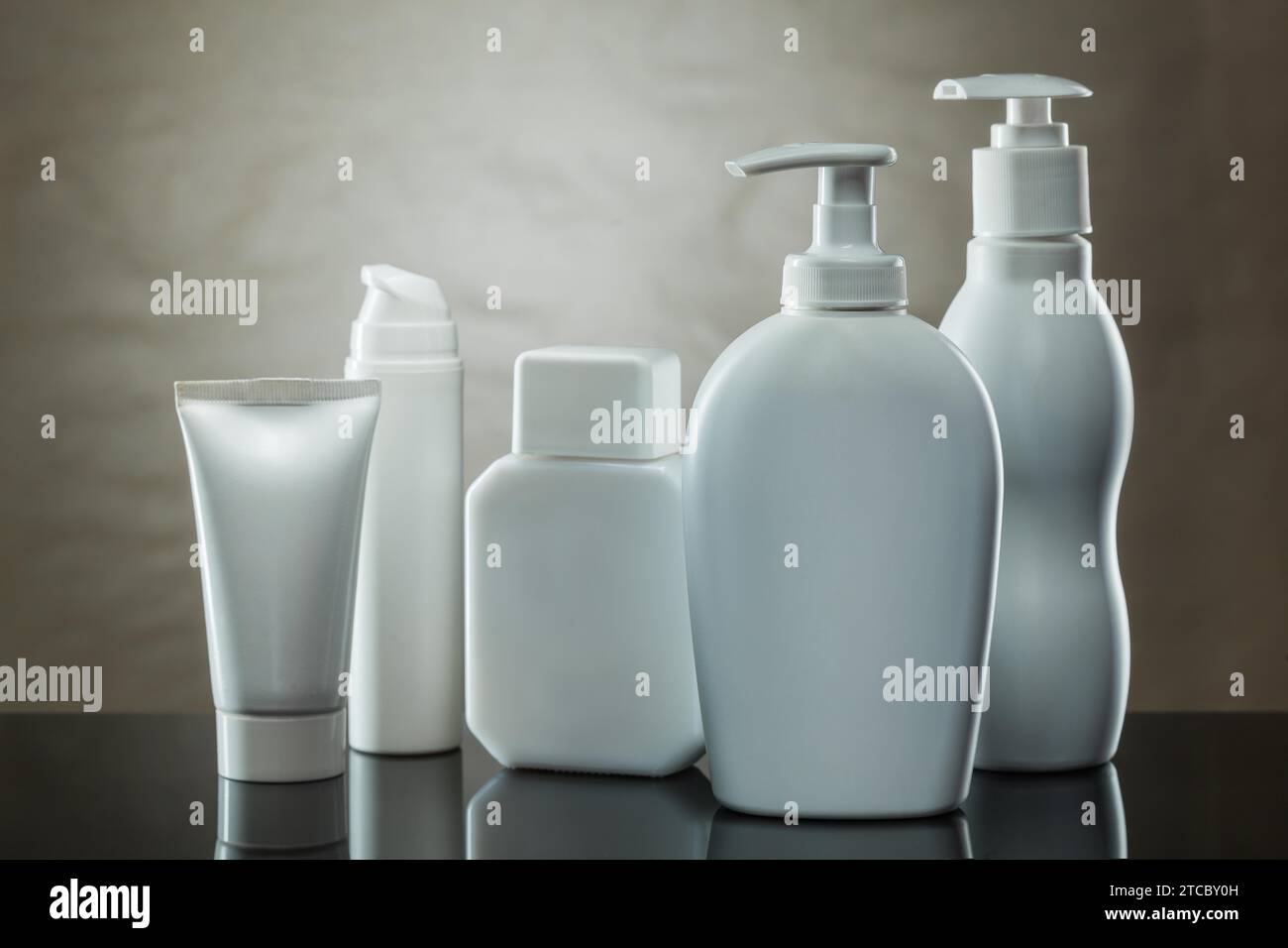 Make-up dispenser tube glass on brown background Stock Photo - Alamy