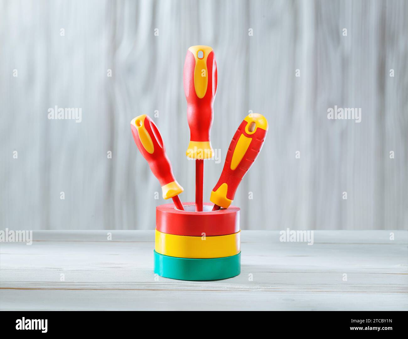 Electrical tools Three screwdrivers standing in rolls of insulating ...