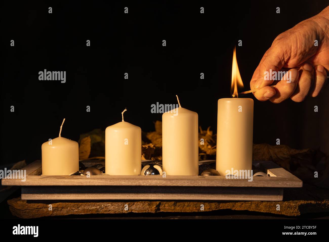 Light the first Advent candle with a match Stock Photo - Alamy