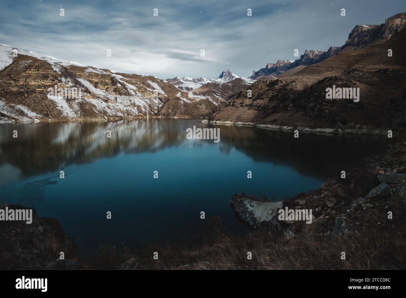 High mountain lake in the northern Caucasus, surrounded by epic rocks ...