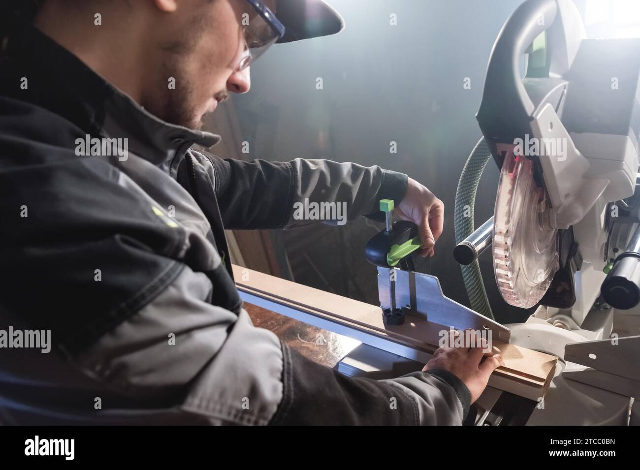 Young brunette man wearing a cap in a gray jacket by profession a ...