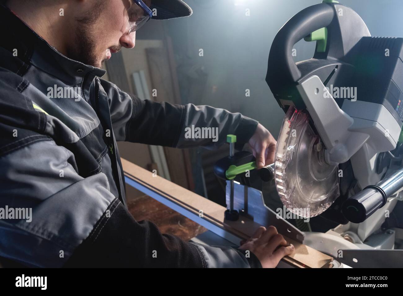 Young brunette man wearing a cap in a gray jacket by profession a ...