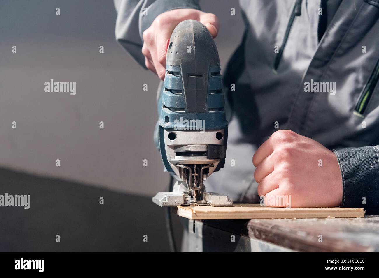 Close up of carpenter's hands working power tools for processing wood ...