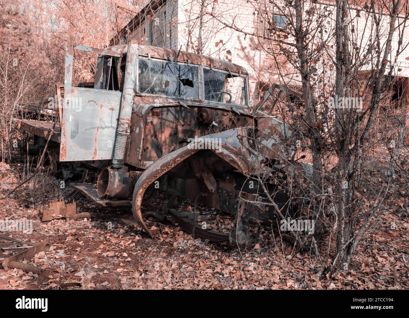 Broken rusty truck near an abandoned brick building in Chernobyl ...