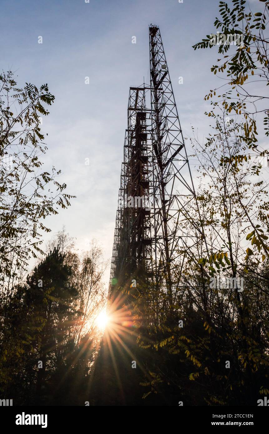 Secret army radar in the forest at sunset with sun rays in Chernobyl ...